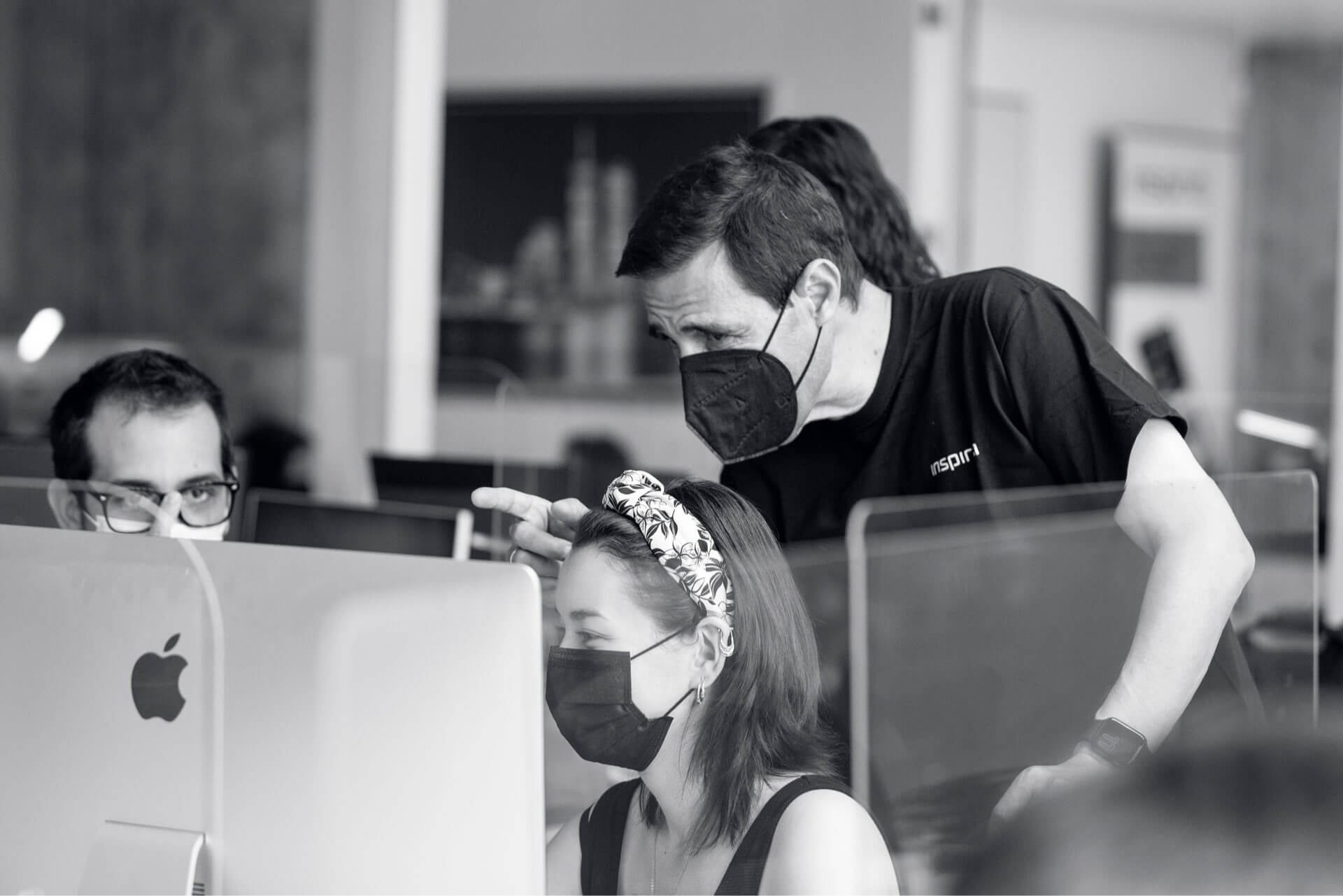 Imagen de tres personas mirando una pantalla de ordenador